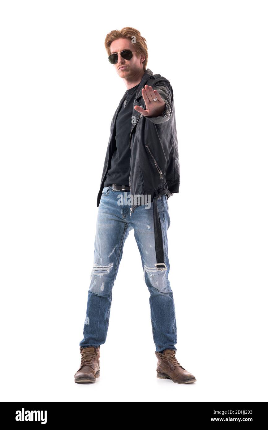 Confident young stylish man biker or rocker style clothes showing stop ...