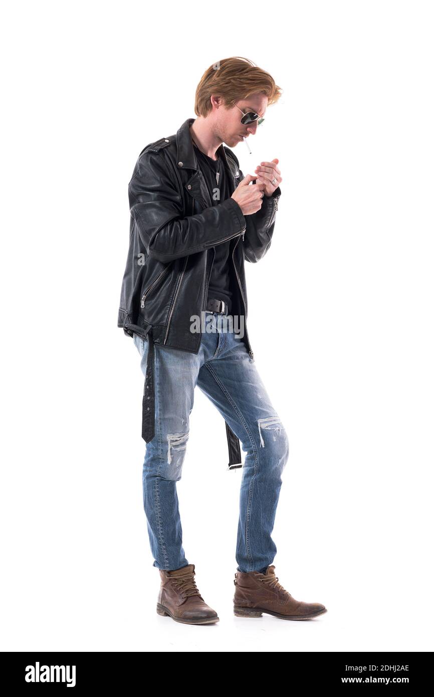 Side view of cool stylish man smoker in black leather jacket and ...