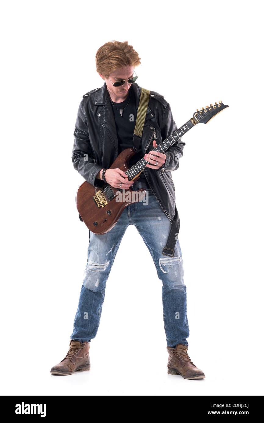 Young stylish redhead rocker with sunglasses playing electric guitar ...