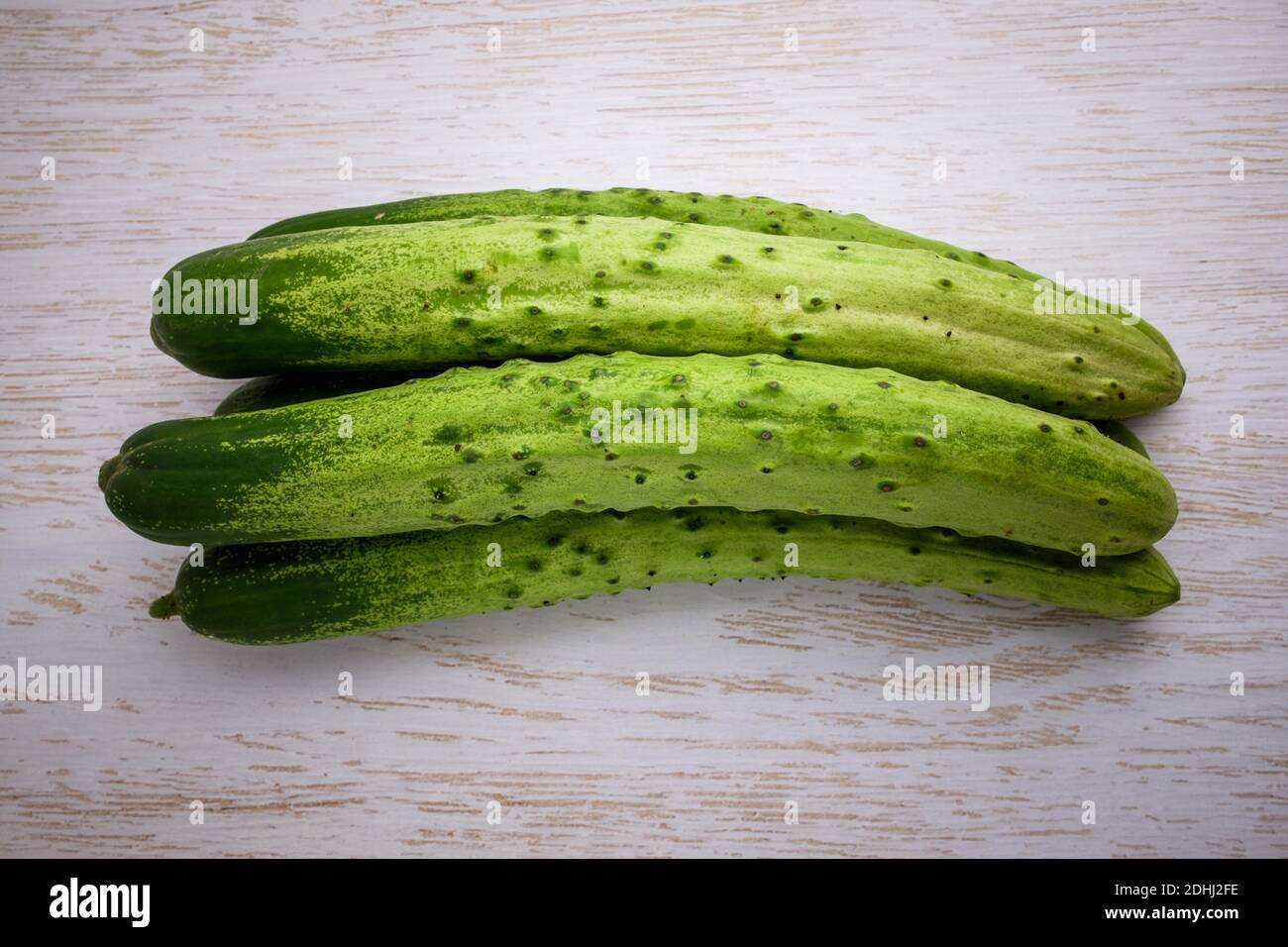 Elongated raw cucumber with background Stock Photo - Alamy