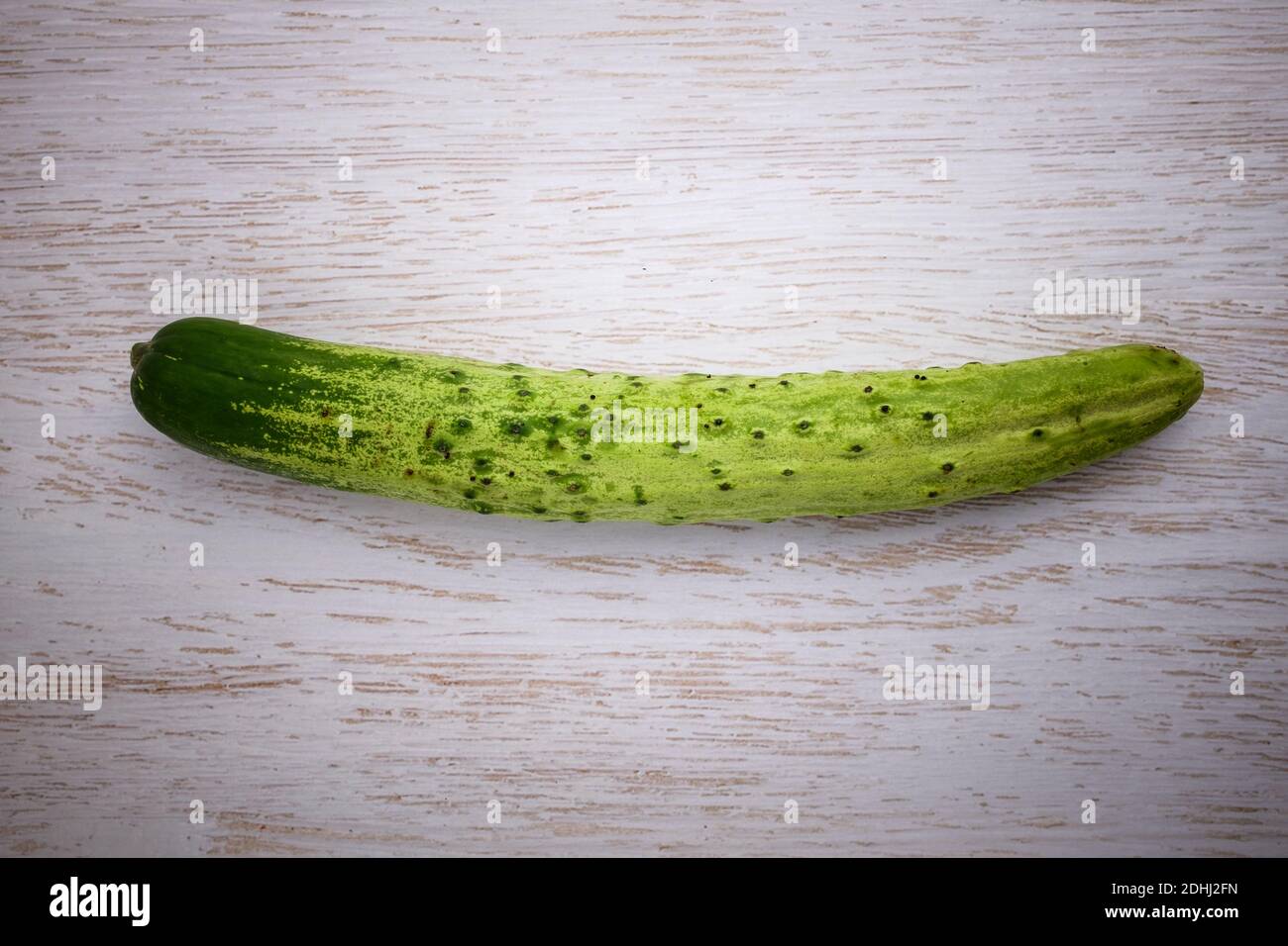 Elongated raw cucumber with background Stock Photo - Alamy