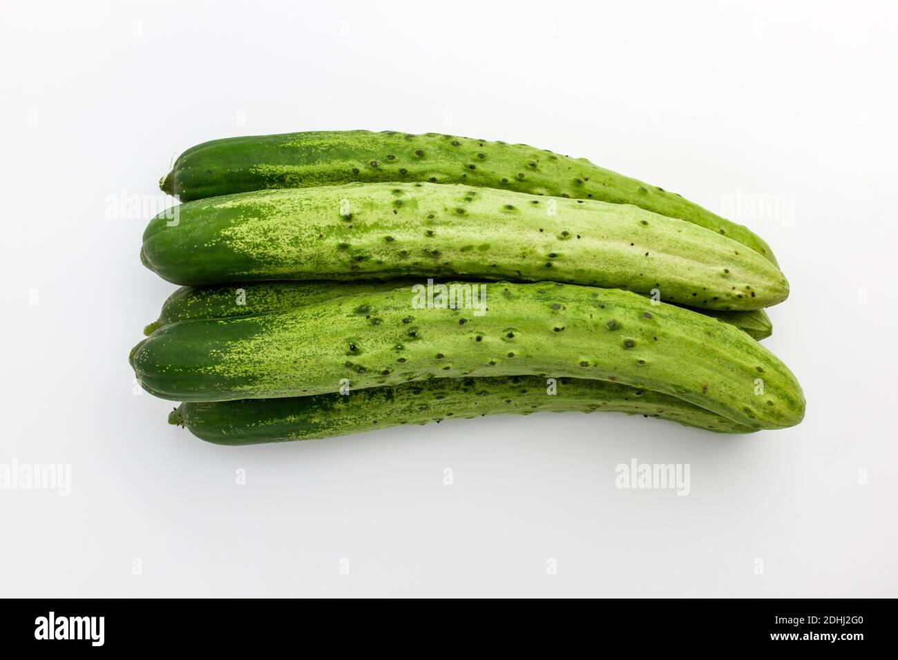 Elongated raw cucumber with background Stock Photo - Alamy