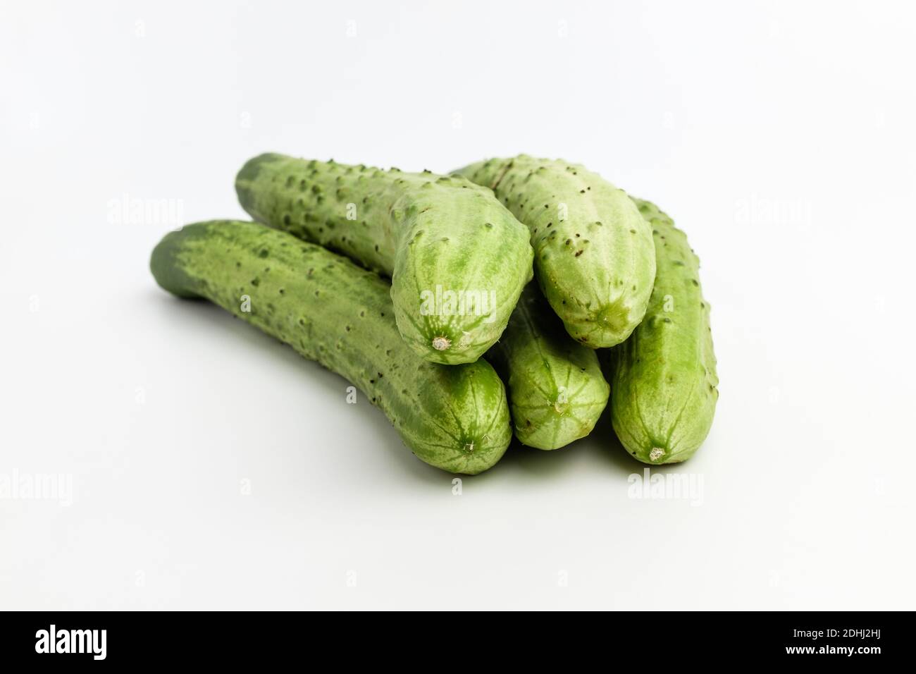 Elongated raw cucumber with background Stock Photo - Alamy