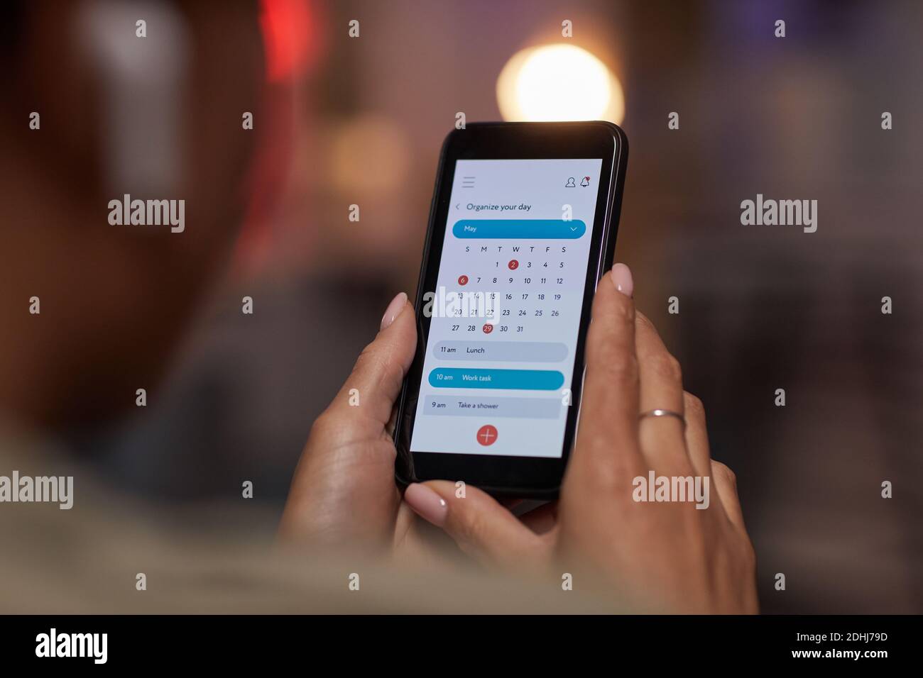 Close-up of woman using online calendar on mobile phone to plan her ...