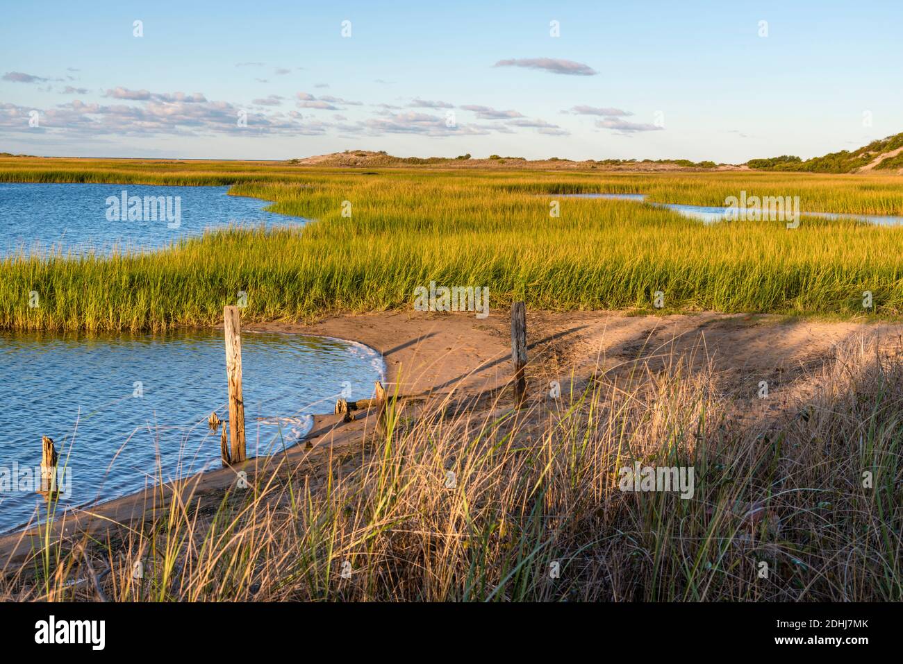 A view of the saltwater marshes with grasslands and breakwater in the ...