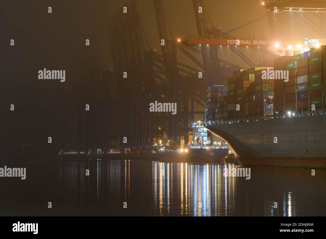Mystical evening scenes at Hamburg port, wrapped in fog and ...