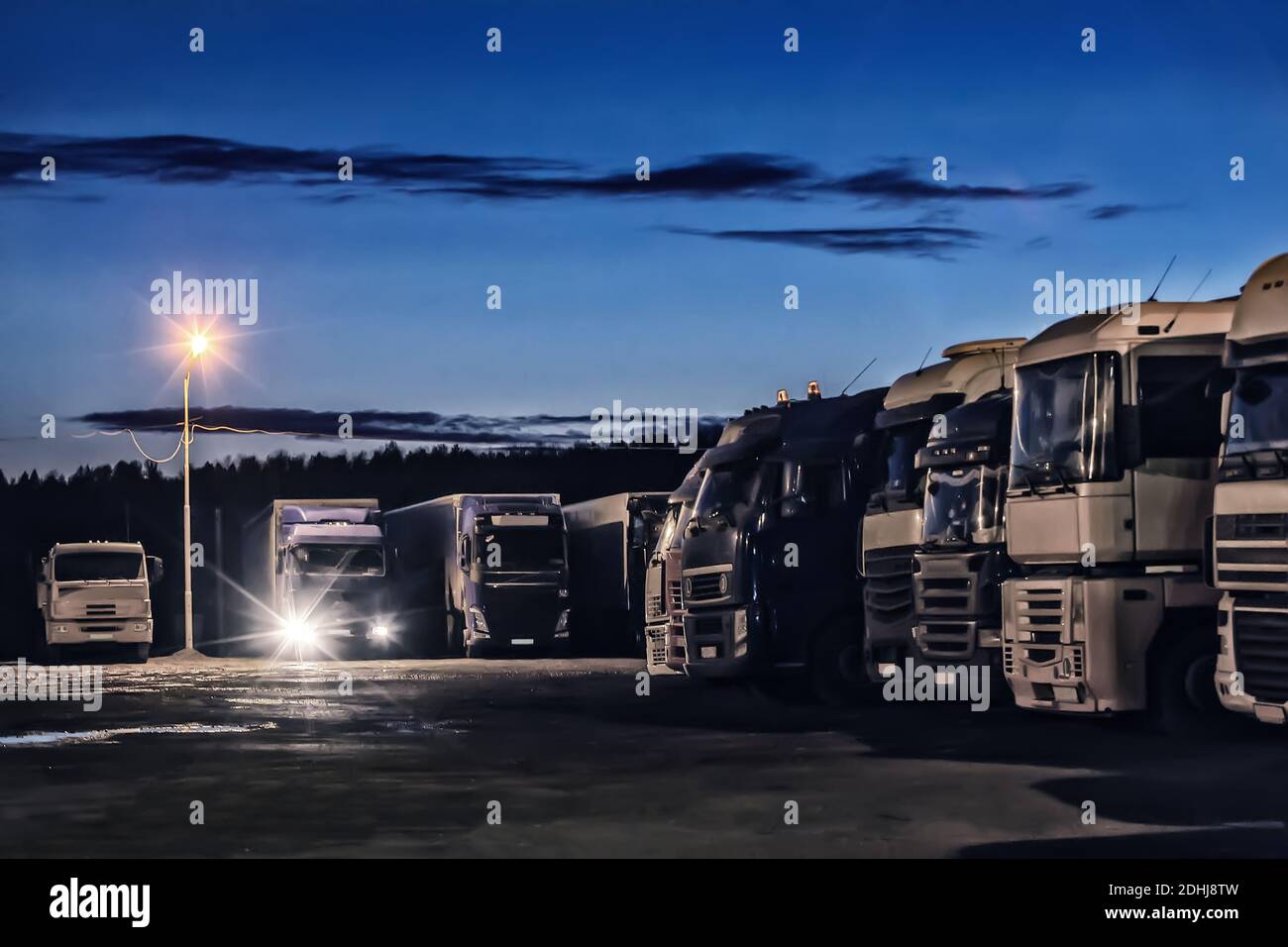 Trucks and semi-trailers in the night Parking lot outside the city by ...