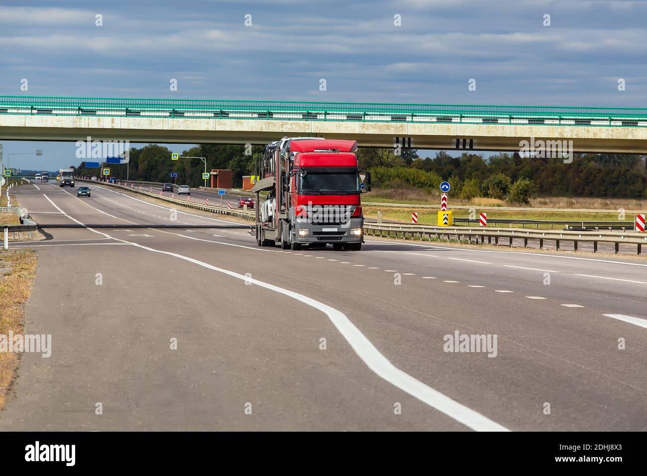 Car transporter carries cars along the highway, side view of the ...