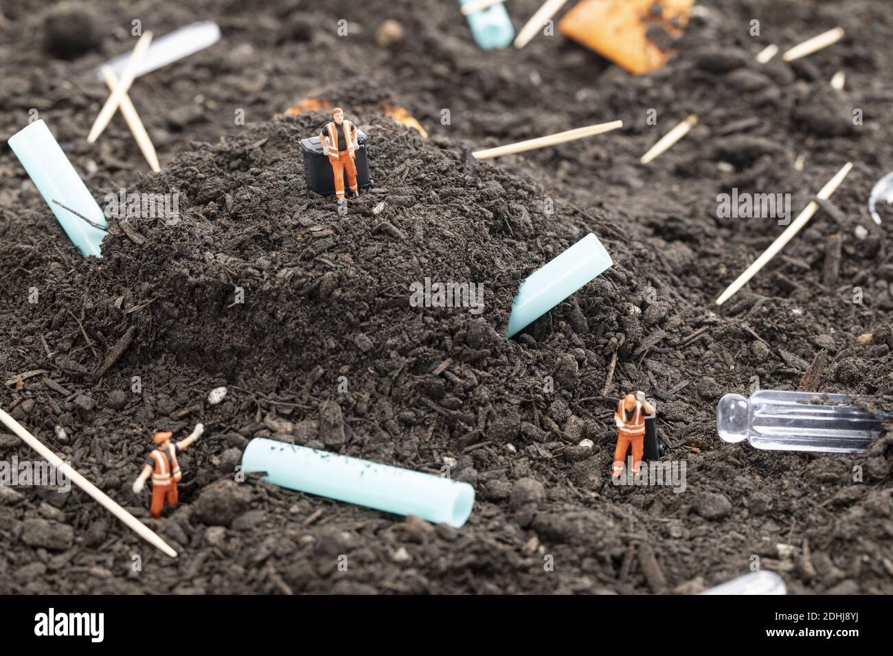 A selective focus shot of garbage and construction worker toys on the ...