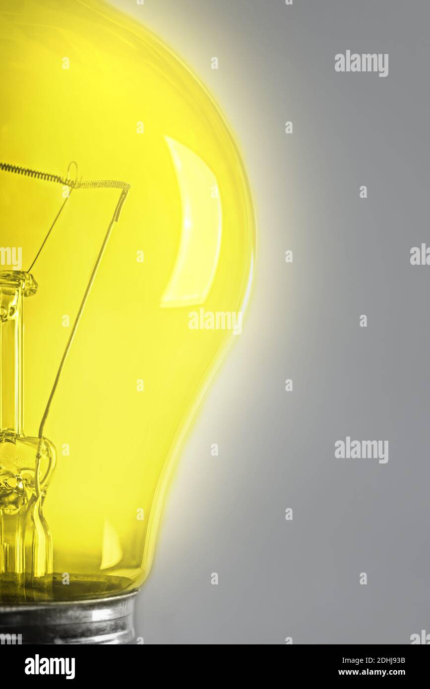 Half glowing light bulb on the gray background. Colors of the year 2021 ...