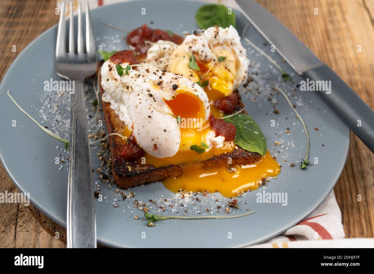 Poached eggs with spread yolk. Egg yolk on a plate. View into dense ...