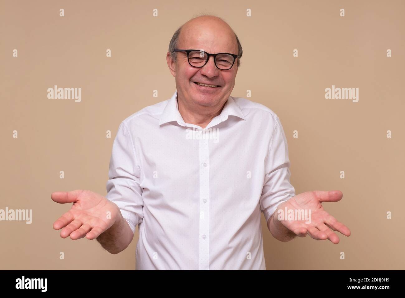 Clueless senior man, arms out saying I do not know. Negative human ...