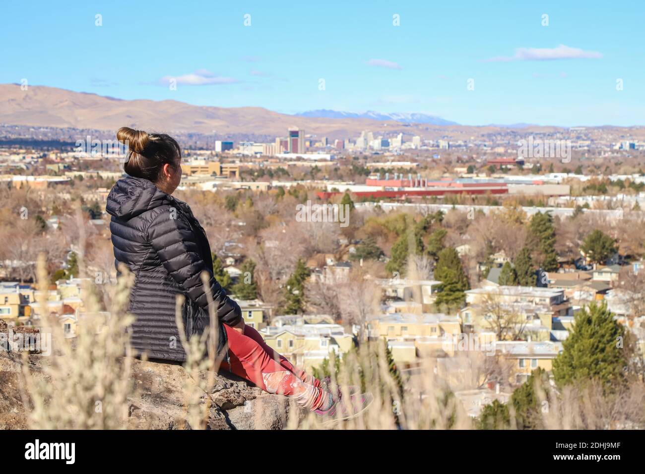 RENO, NEVADA, UNITED STATES - Dec 07, 2020: A woman sits on a rock ...