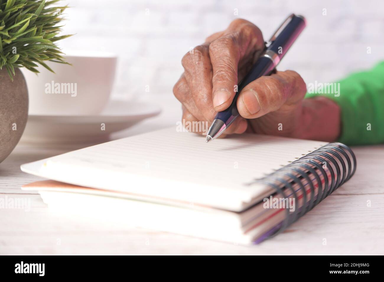 Close up of senior women hand writing on notepad Stock Photo - Alamy