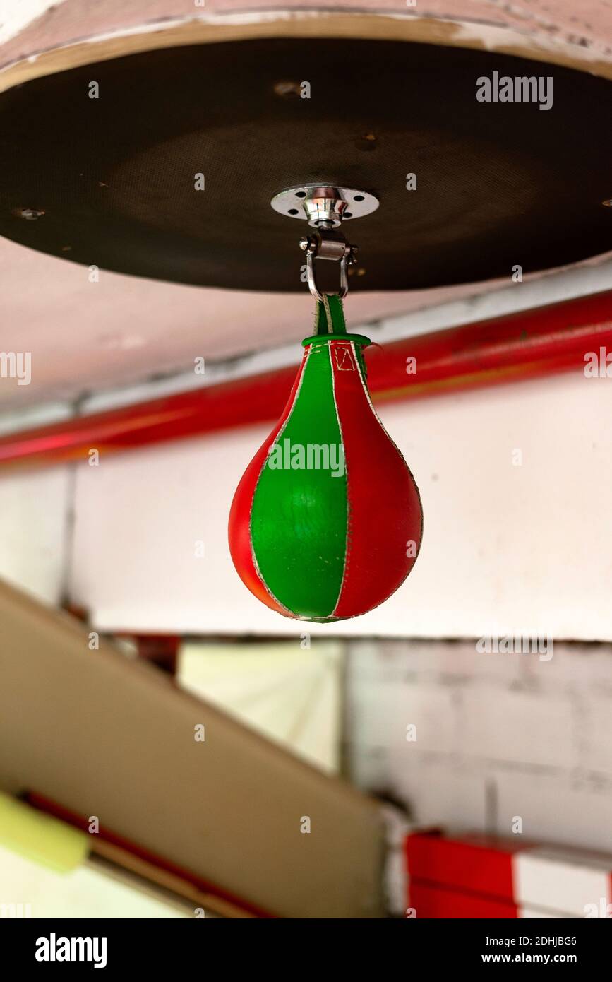 Green and red punching bag at a boxing gym Stock Photo - Alamy
