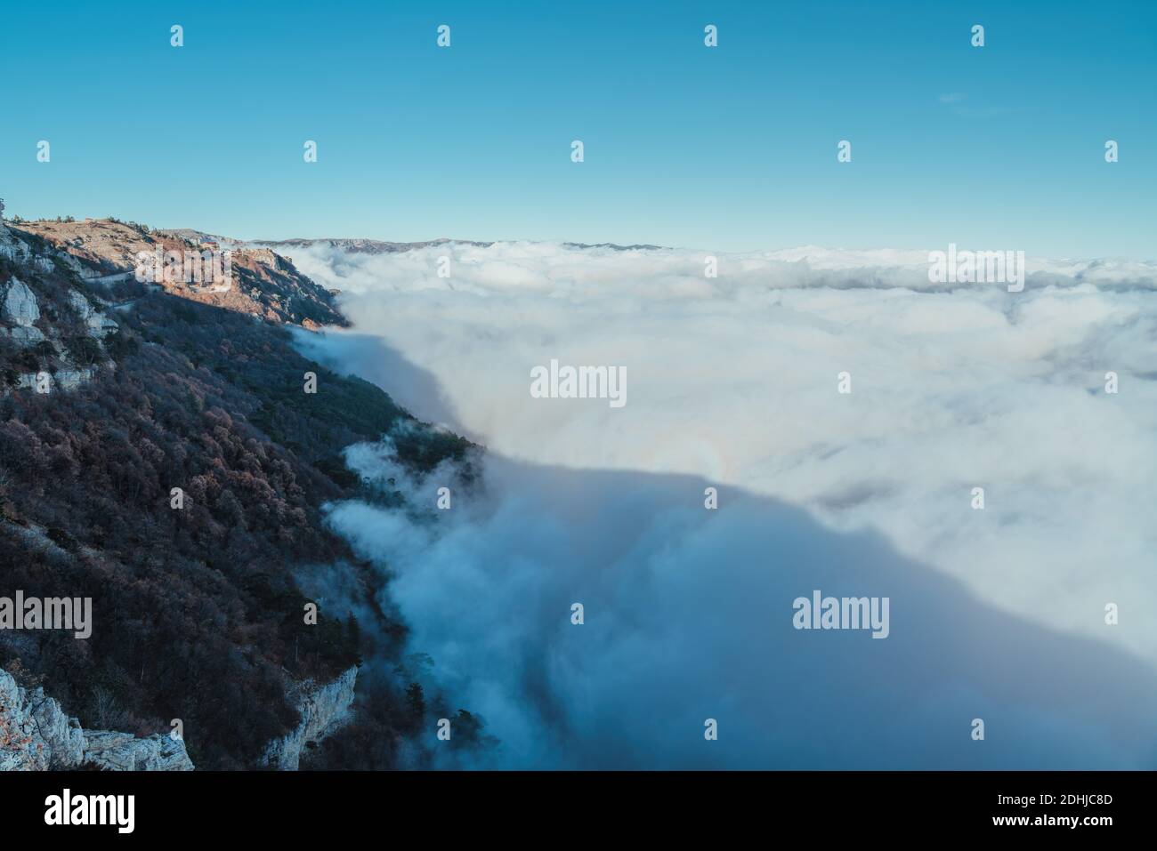 Broken ghost high in the mountains above the fog waves, surrounded by ...