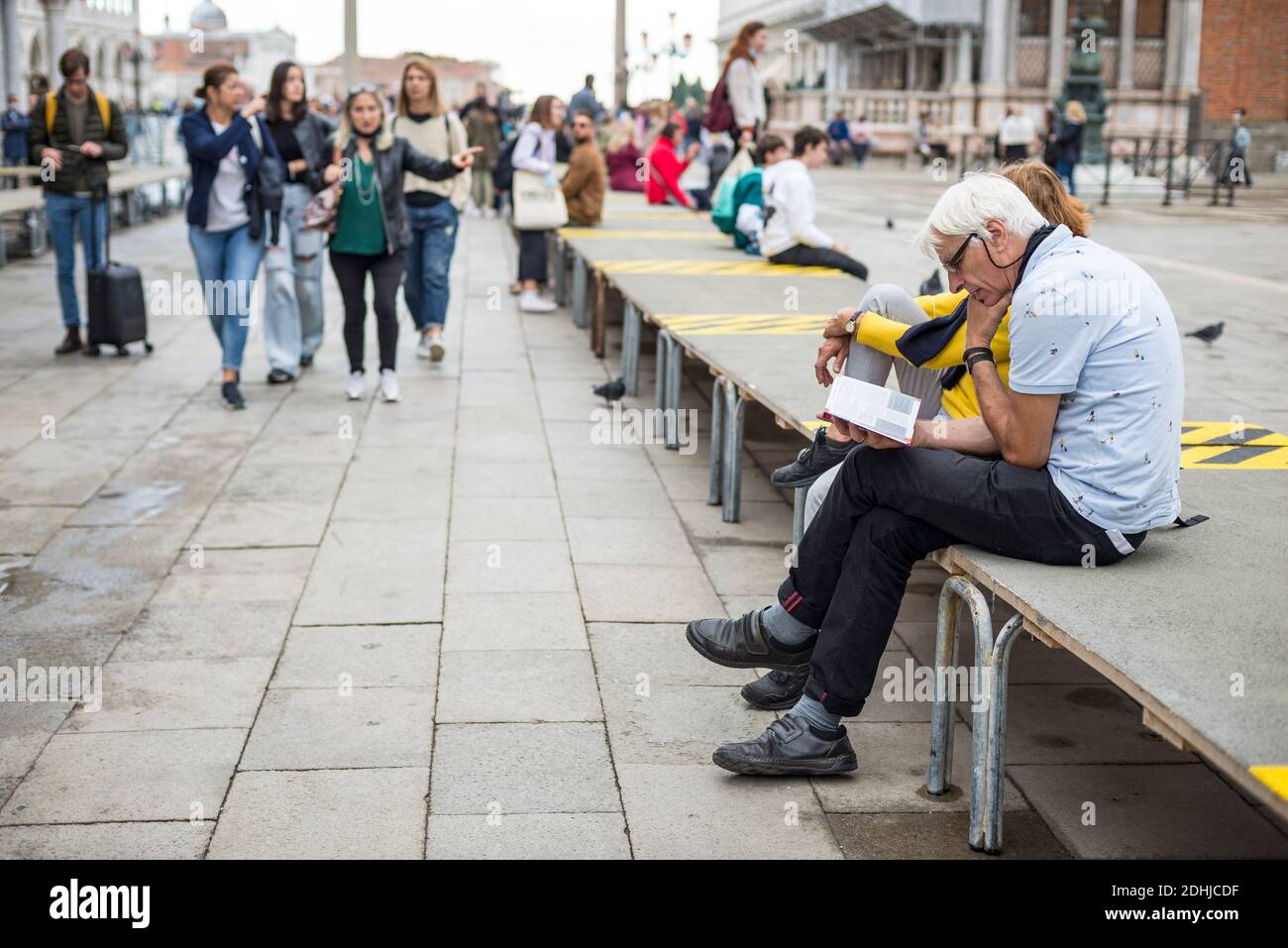 Social distancing and reading a guidebook in the not so busy Piazza San ...