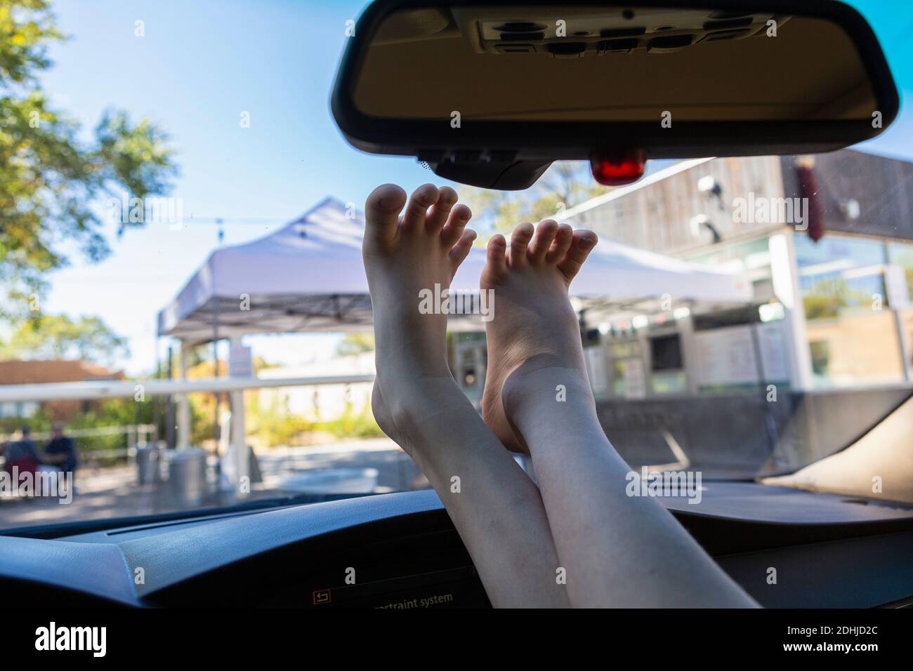 Young boy's bare feet resting on dashboard of car Stock Photo - Alamy