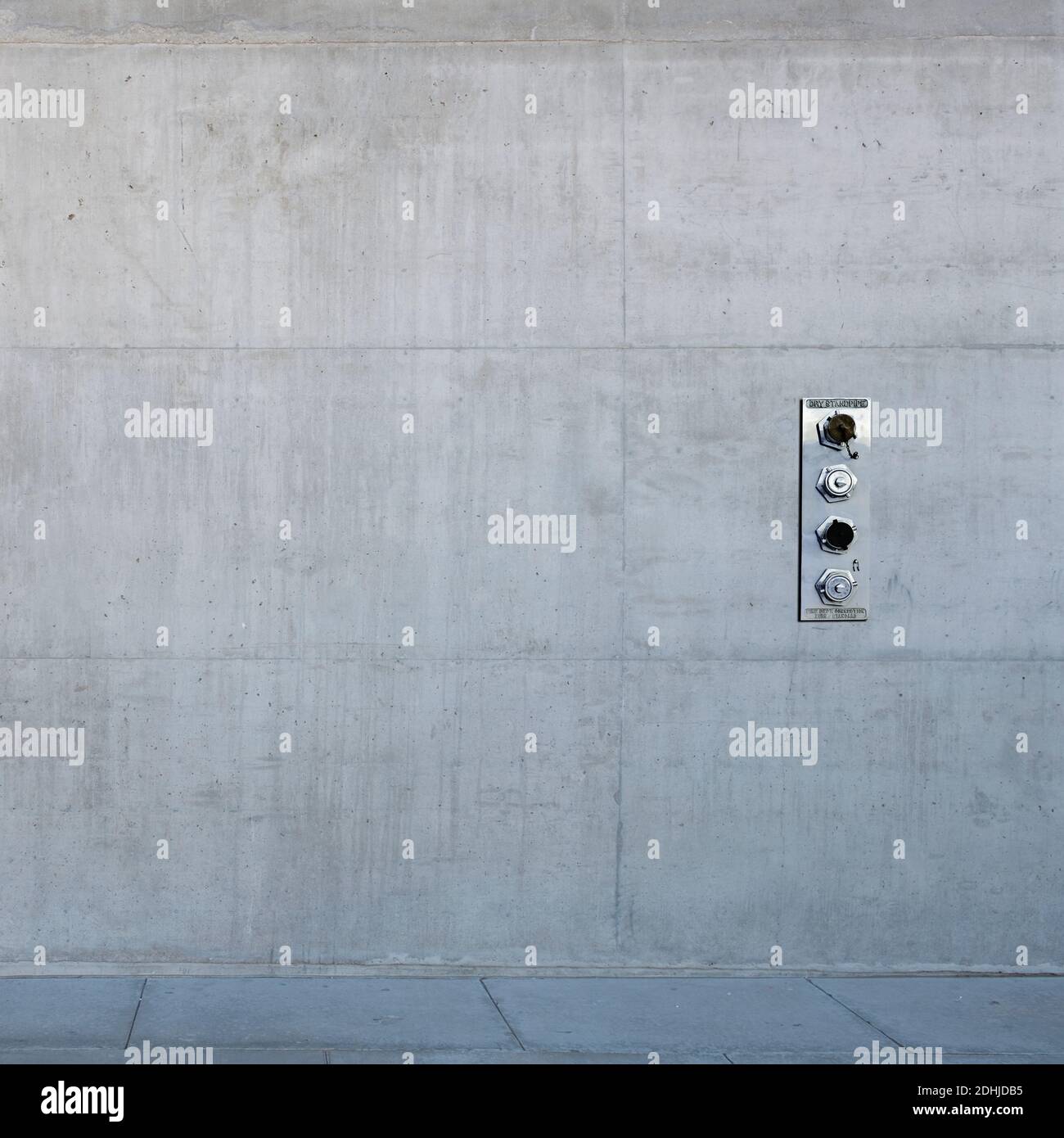 Metal control panel on concrete wall Stock Photo - Alamy