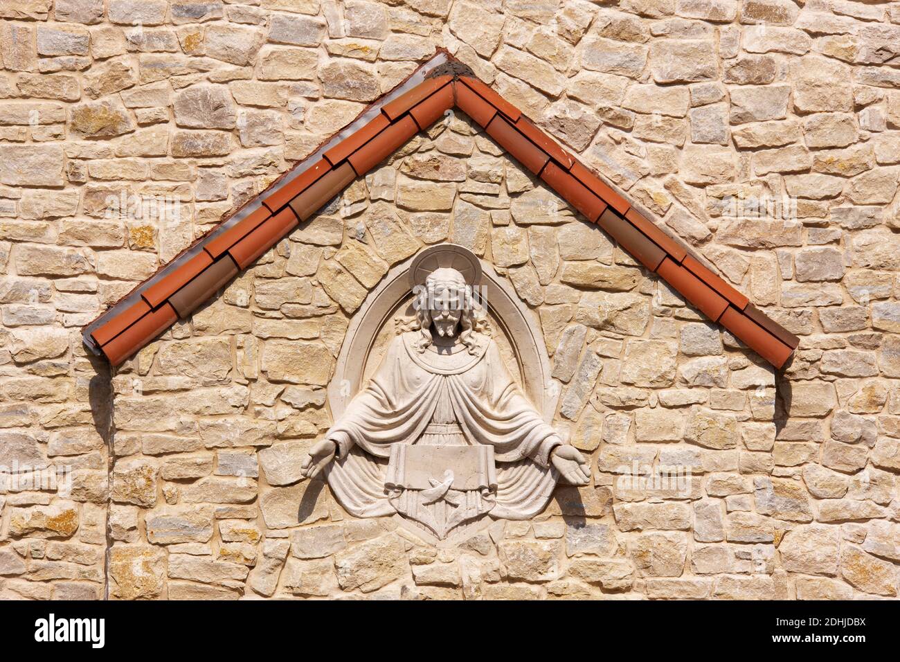 Sculpture of Jesus set into stone wall Stock Photo - Alamy