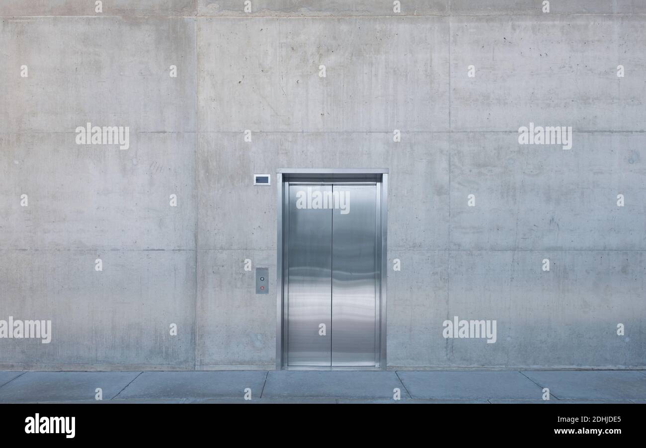 Metal elevator doors in a concrete wall Stock Photo - Alamy