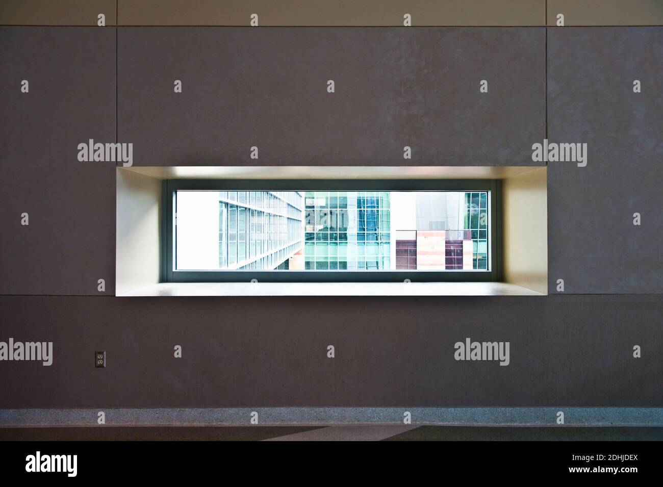 Window in wall onto business district skyscrapers Stock Photo - Alamy