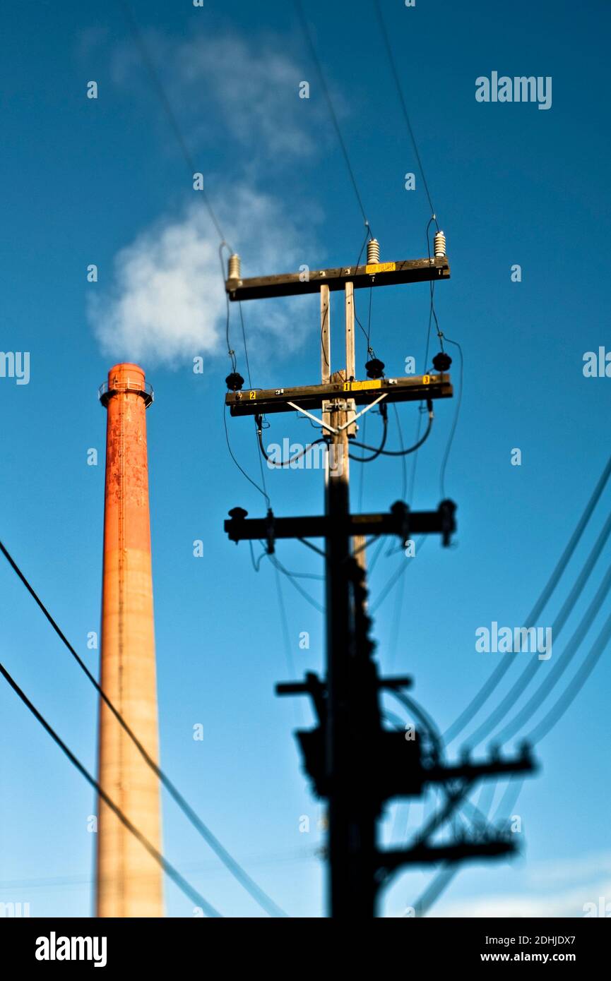 Power line with industrial chimney Stock Photo - Alamy