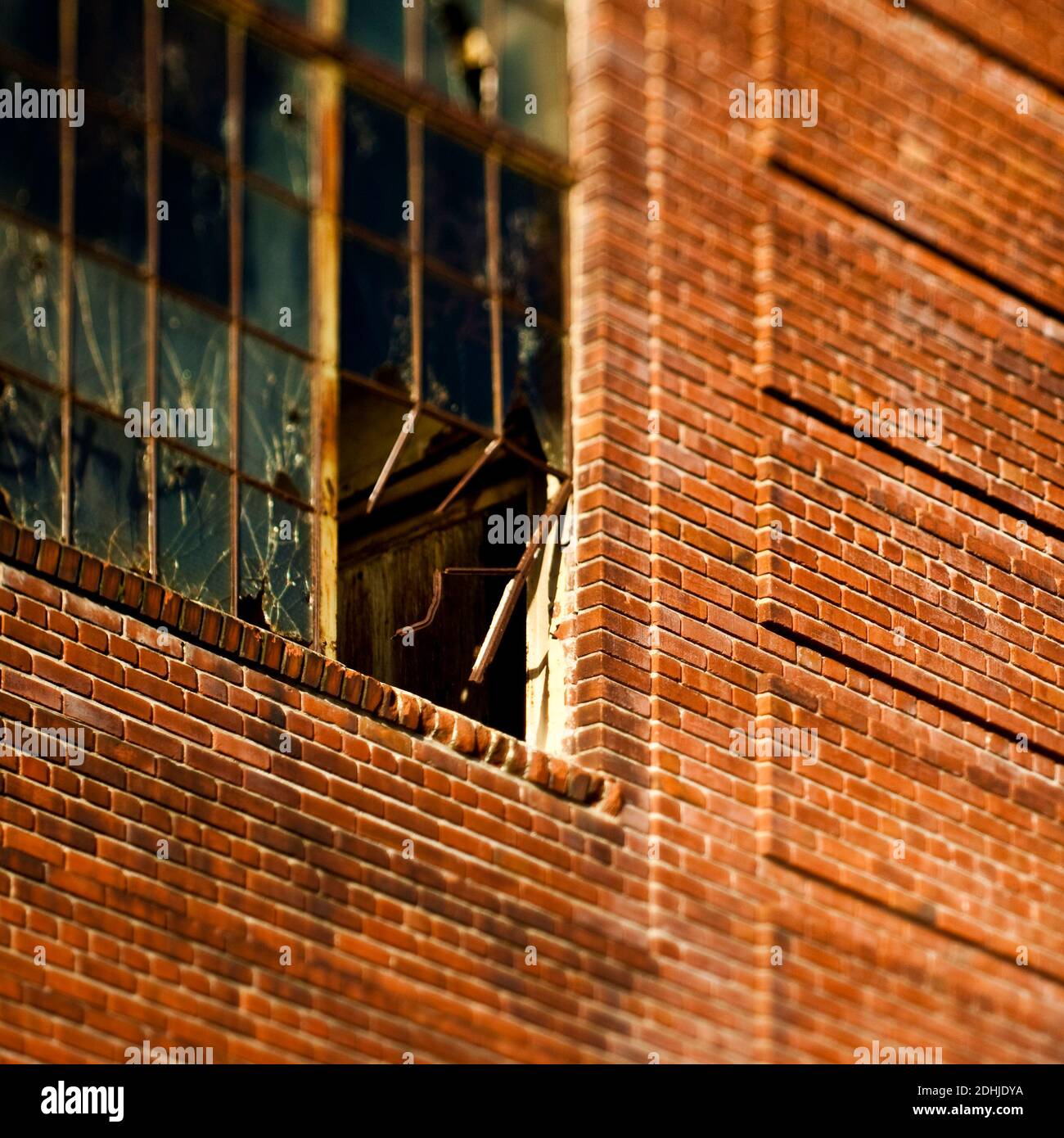Broken window in brick warehouse Stock Photo - Alamy