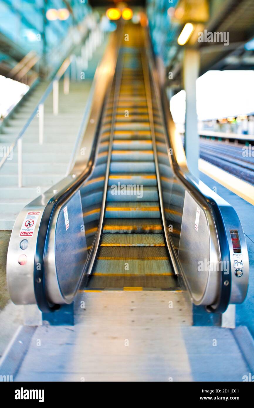Escalator on railway station platform Stock Photo - Alamy