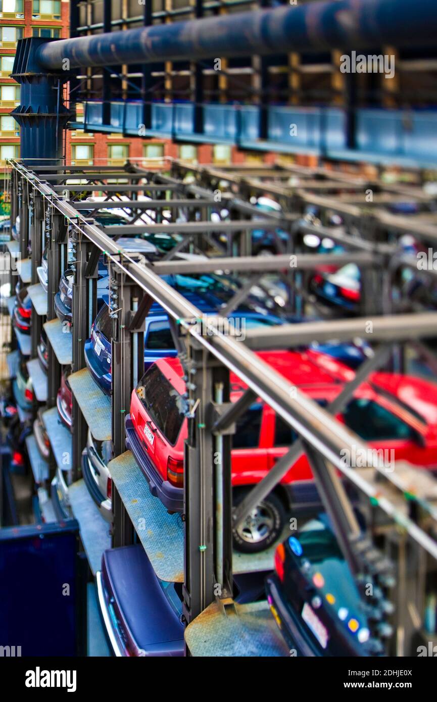 Cars stored in large metal lift Stock Photo - Alamy