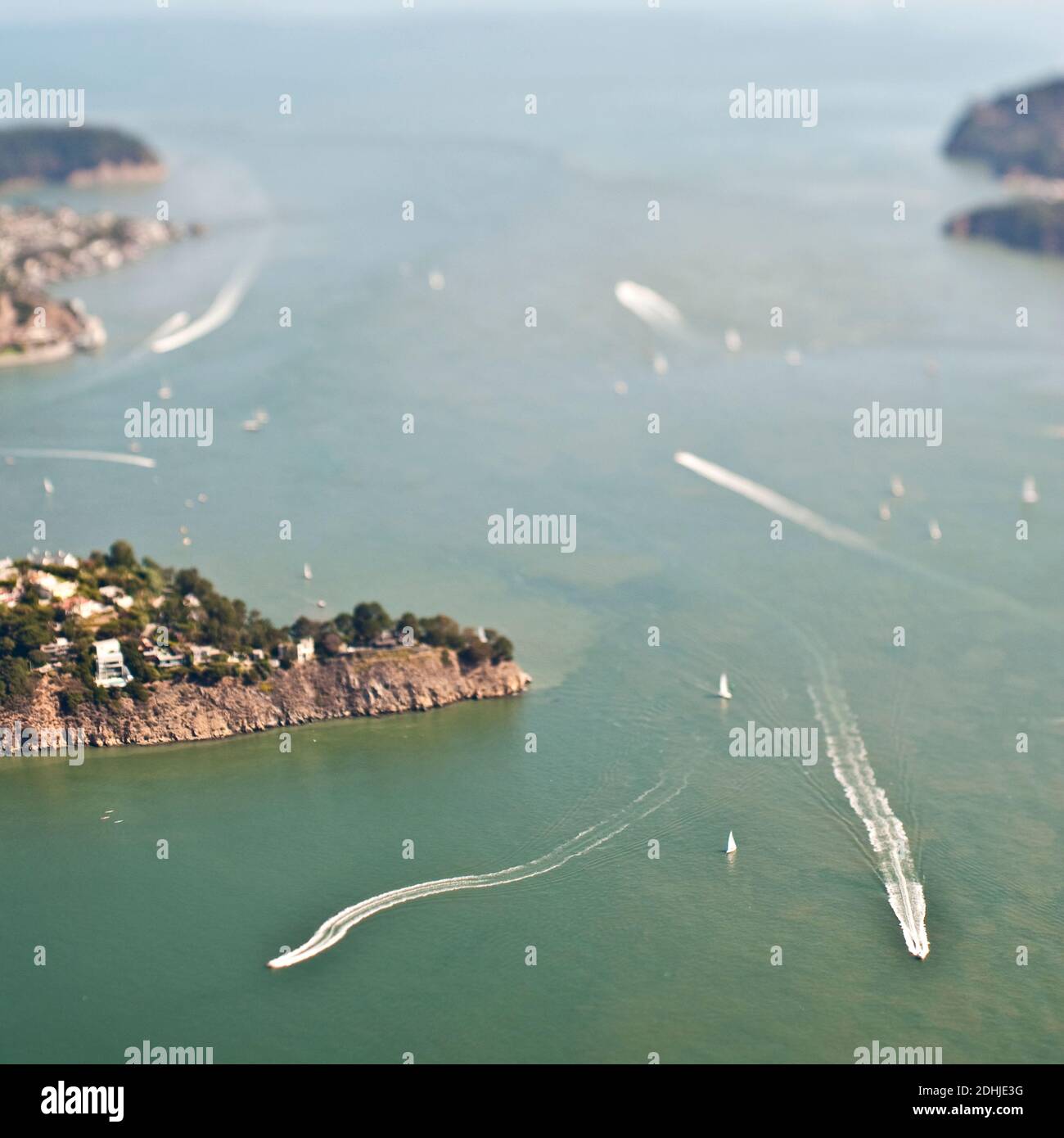 Boats in ocean sailing around islands Stock Photo - Alamy