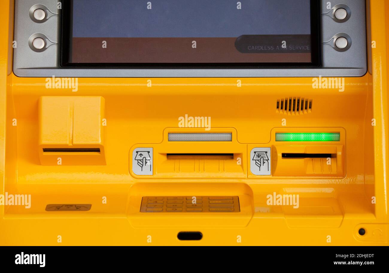 Close-up of yellow ATM machine Stock Photo - Alamy
