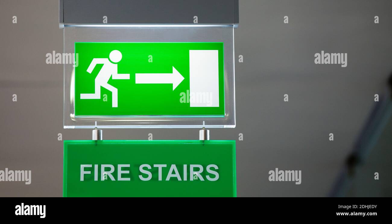 Green lit emergency exit sign hi-res stock photography and images - Alamy