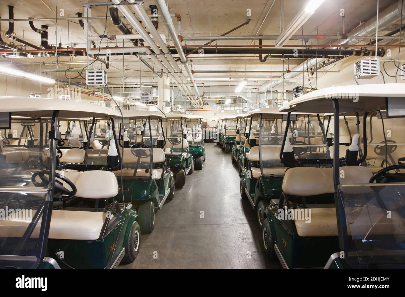 Golf carts in storage Stock Photo - Alamy