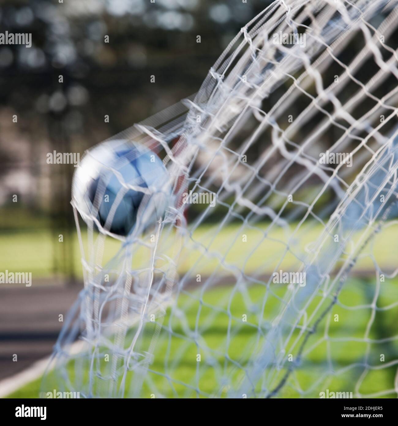 Soccer ball hitting the back of a football net Stock Photo - Alamy