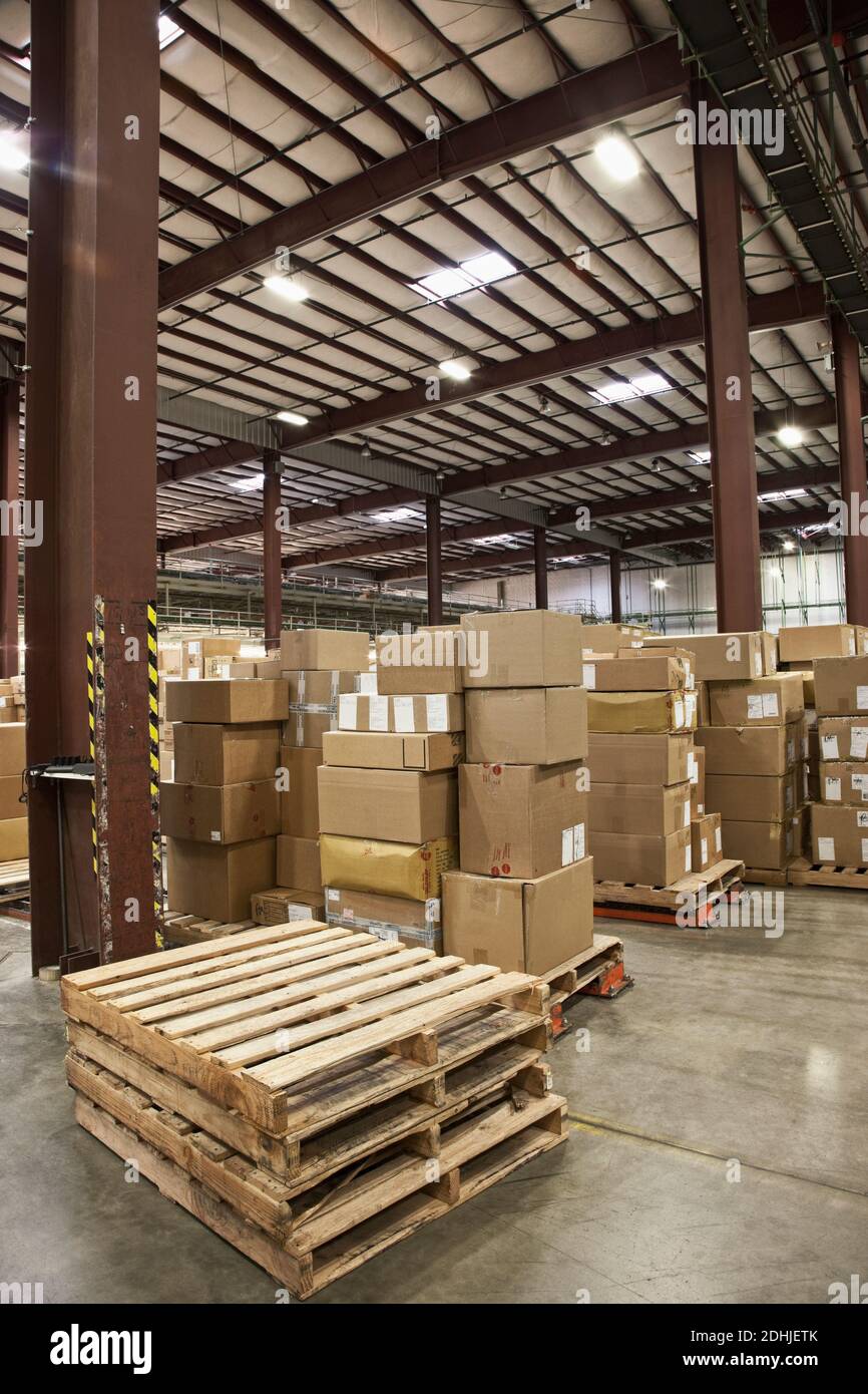 Cardboard boxes and pallets in warehouse Stock Photo - Alamy