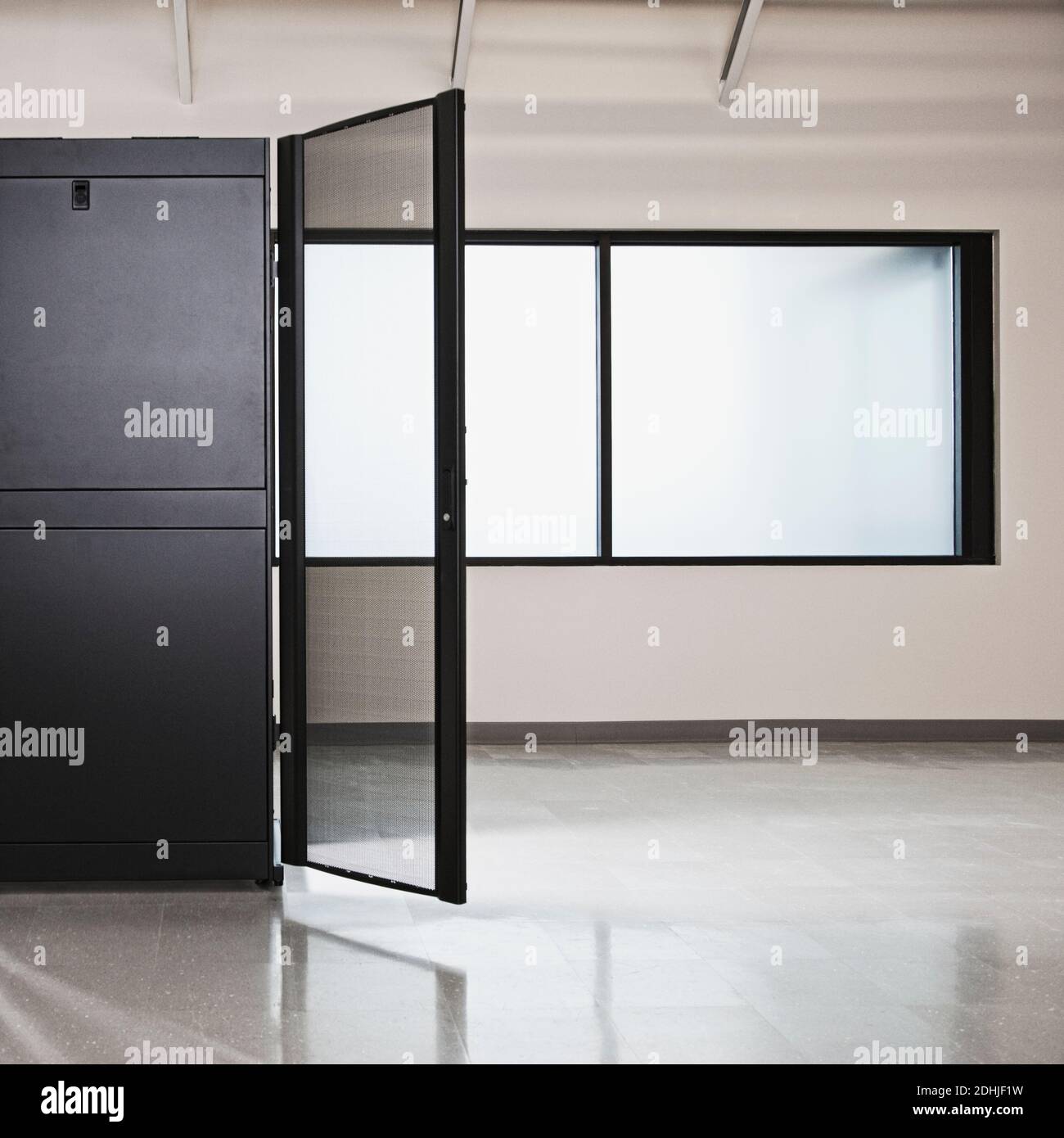 Computer server cabinet with door open and window in office Stock Photo ...