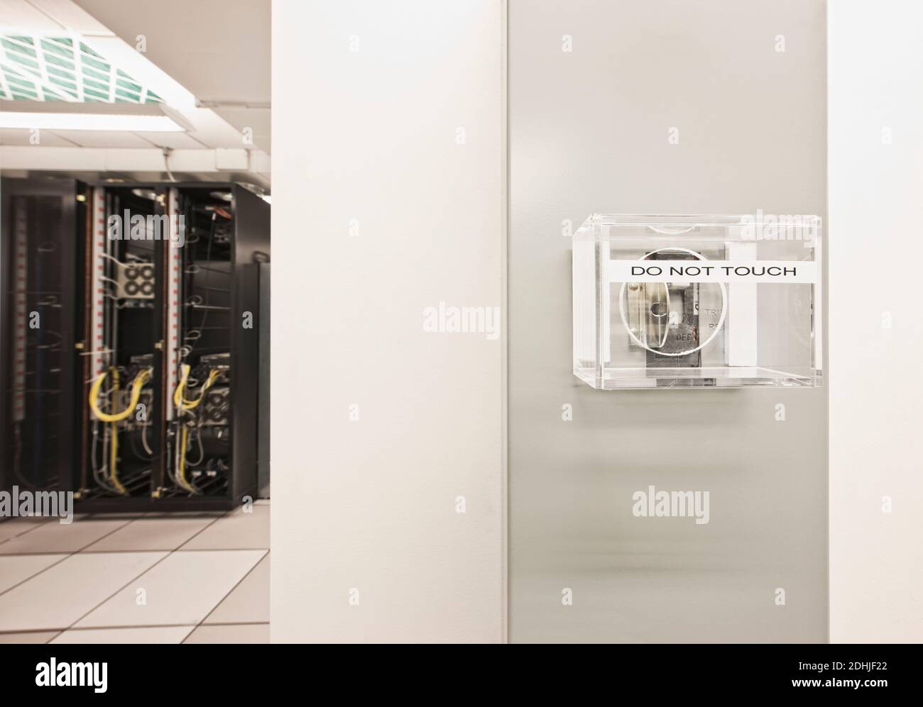 Mains power switch in computer server room with computer server cabinet ...