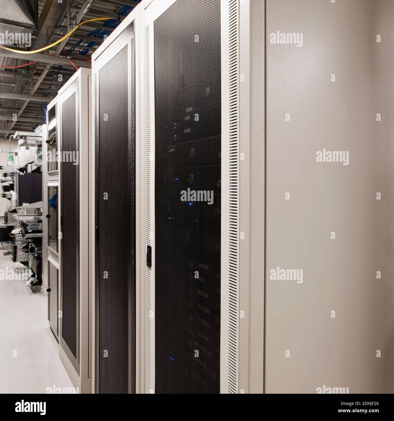 Computer servers in cabinet Stock Photo - Alamy