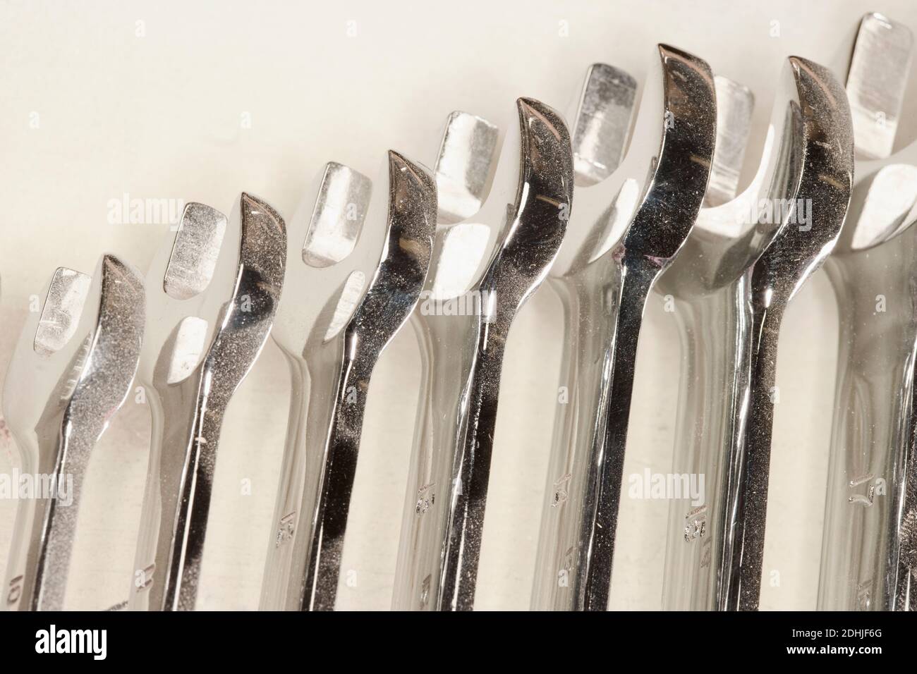 Metal spanners lined up in size order with dust Stock Photo - Alamy