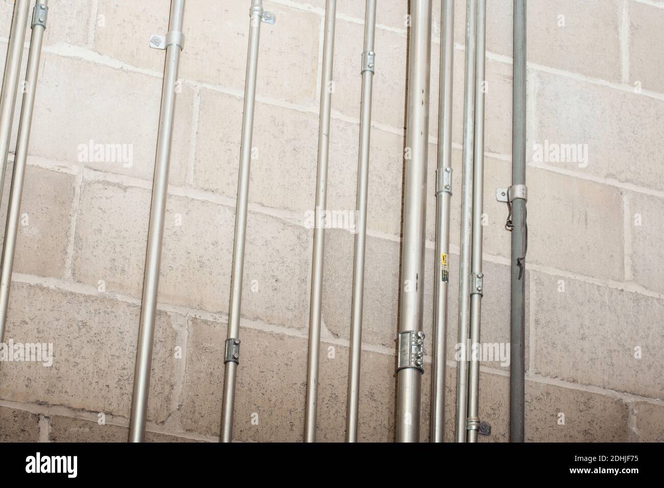 Metal casing for wires on concrete wall Stock Photo - Alamy