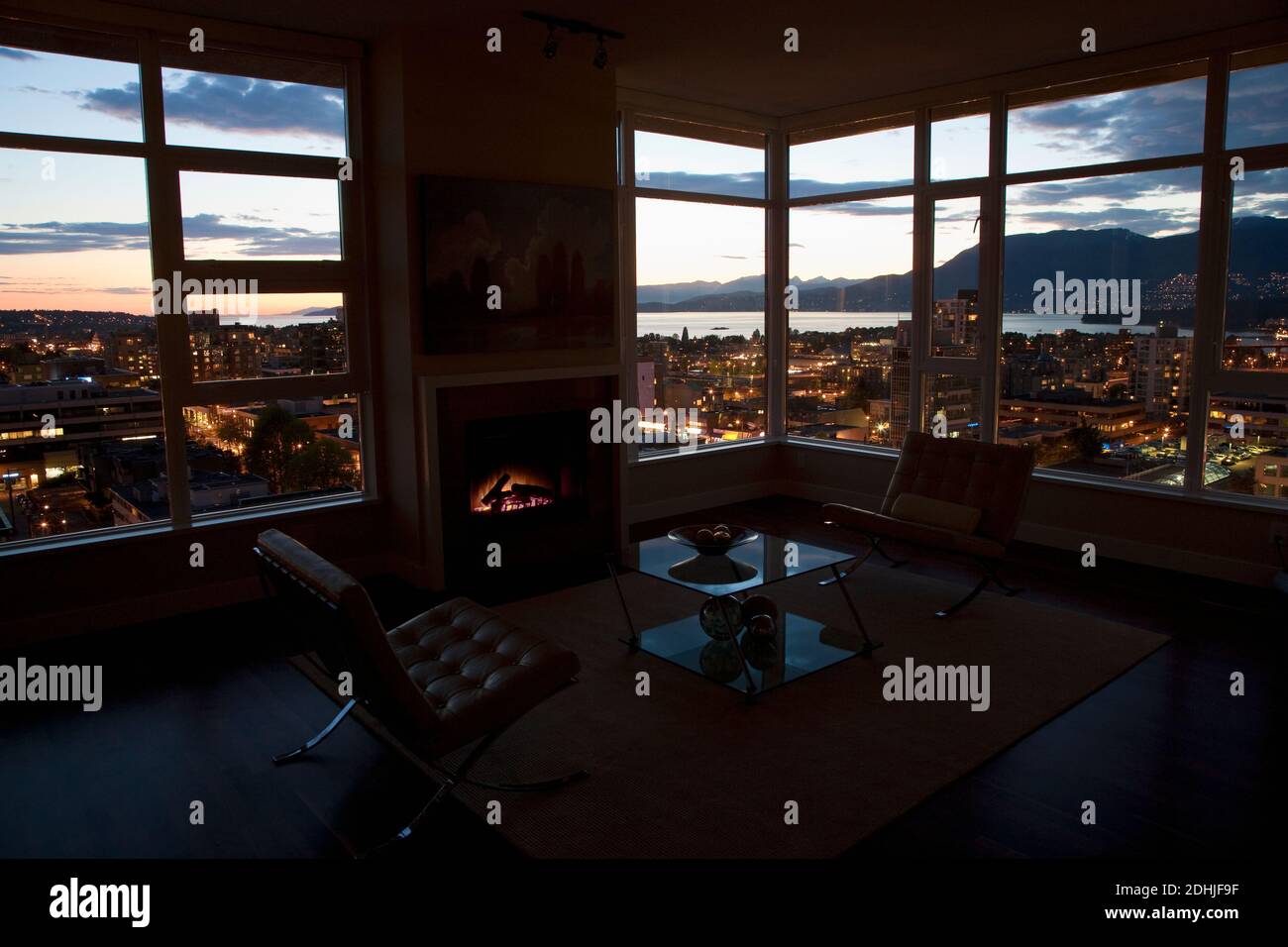 City at night through windows of open plan apartment Stock Photo - Alamy