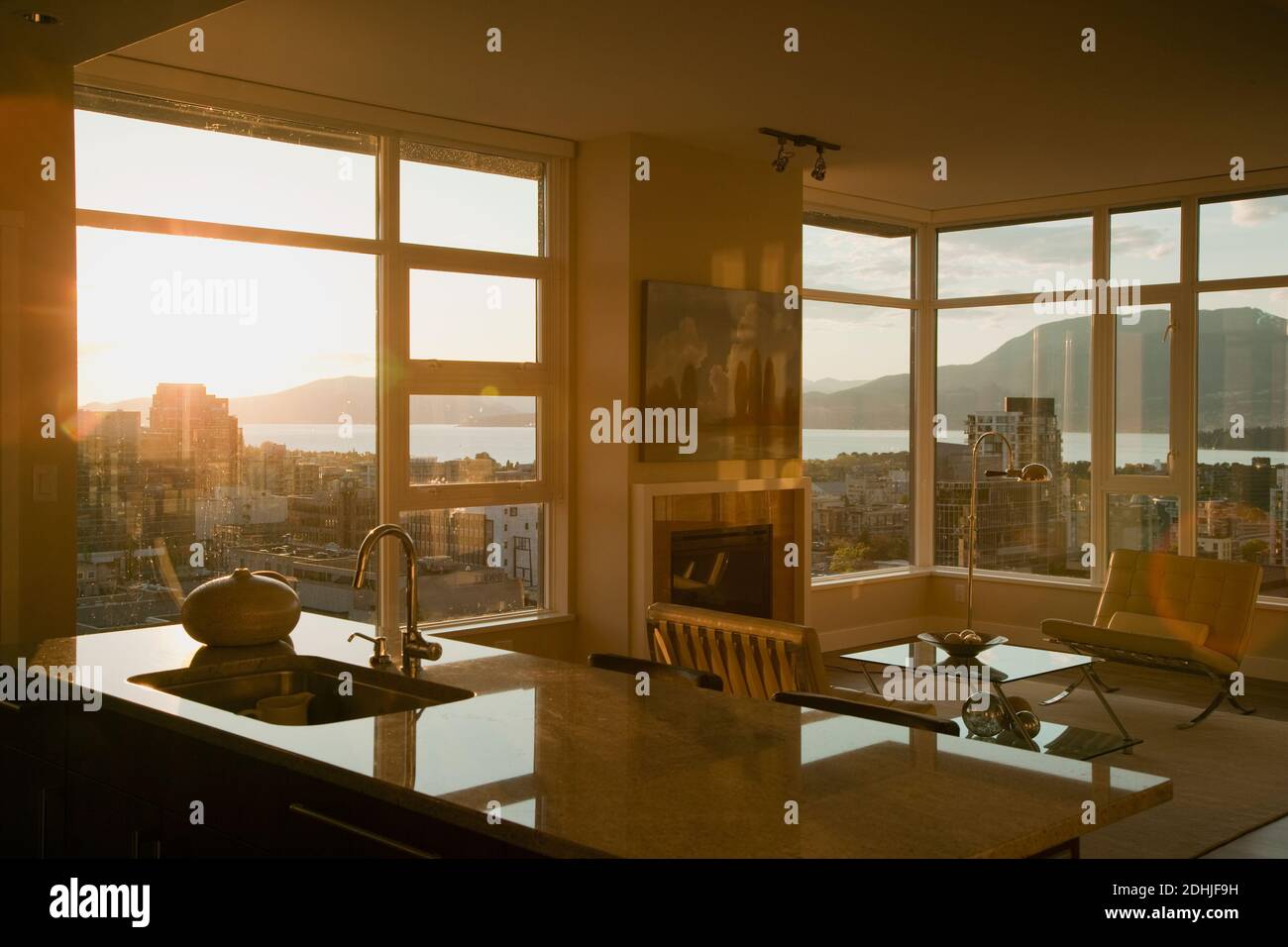 Sunset through windows of open plan apartment Stock Photo - Alamy