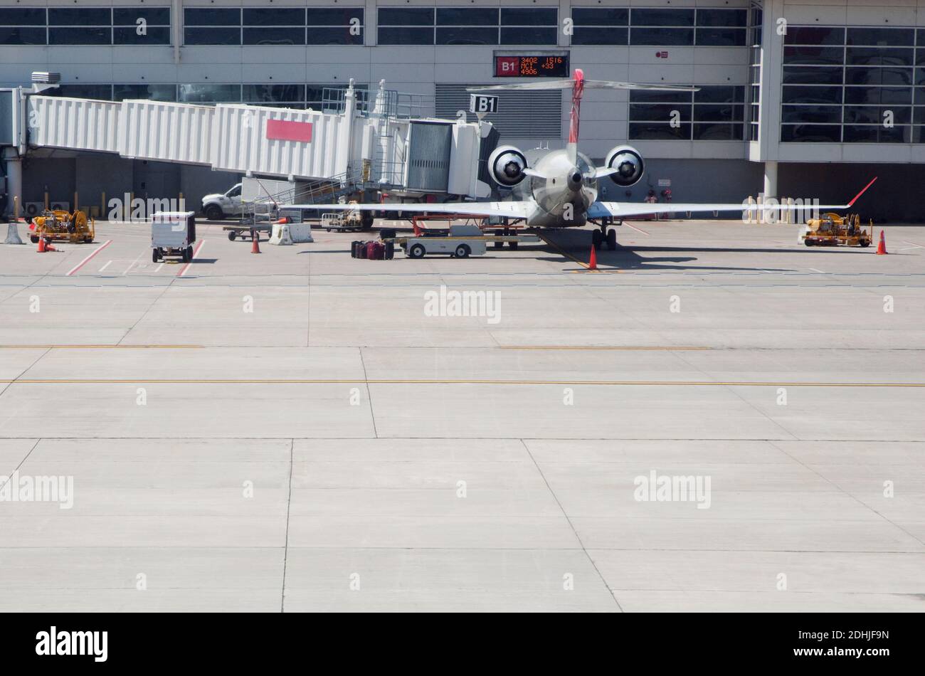 Airplane with air bridge at airport Stock Photo - Alamy