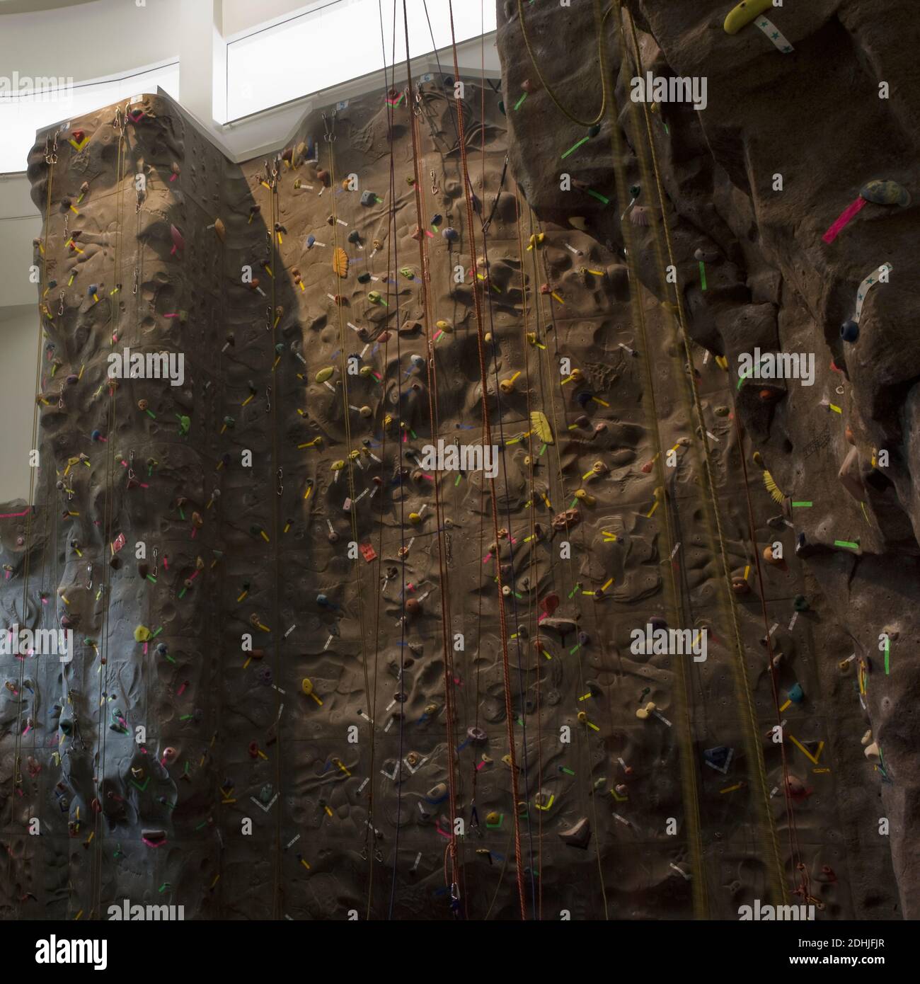 Artificial climbing wall with ropes in indoor climbing centre Stock ...