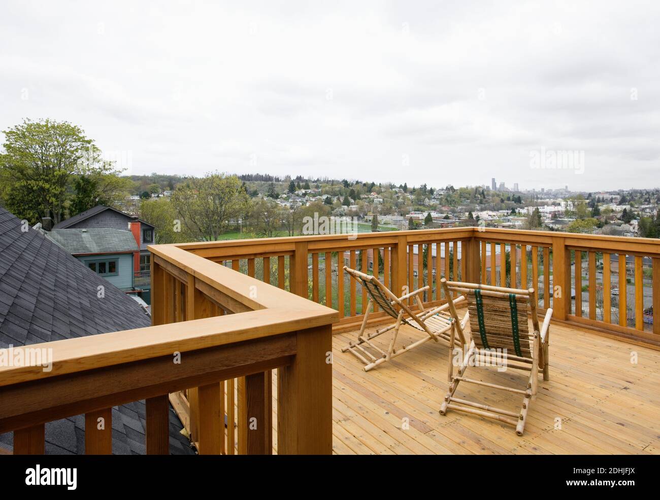 Wooden house balcony looking out over urban area Stock Photo - Alamy