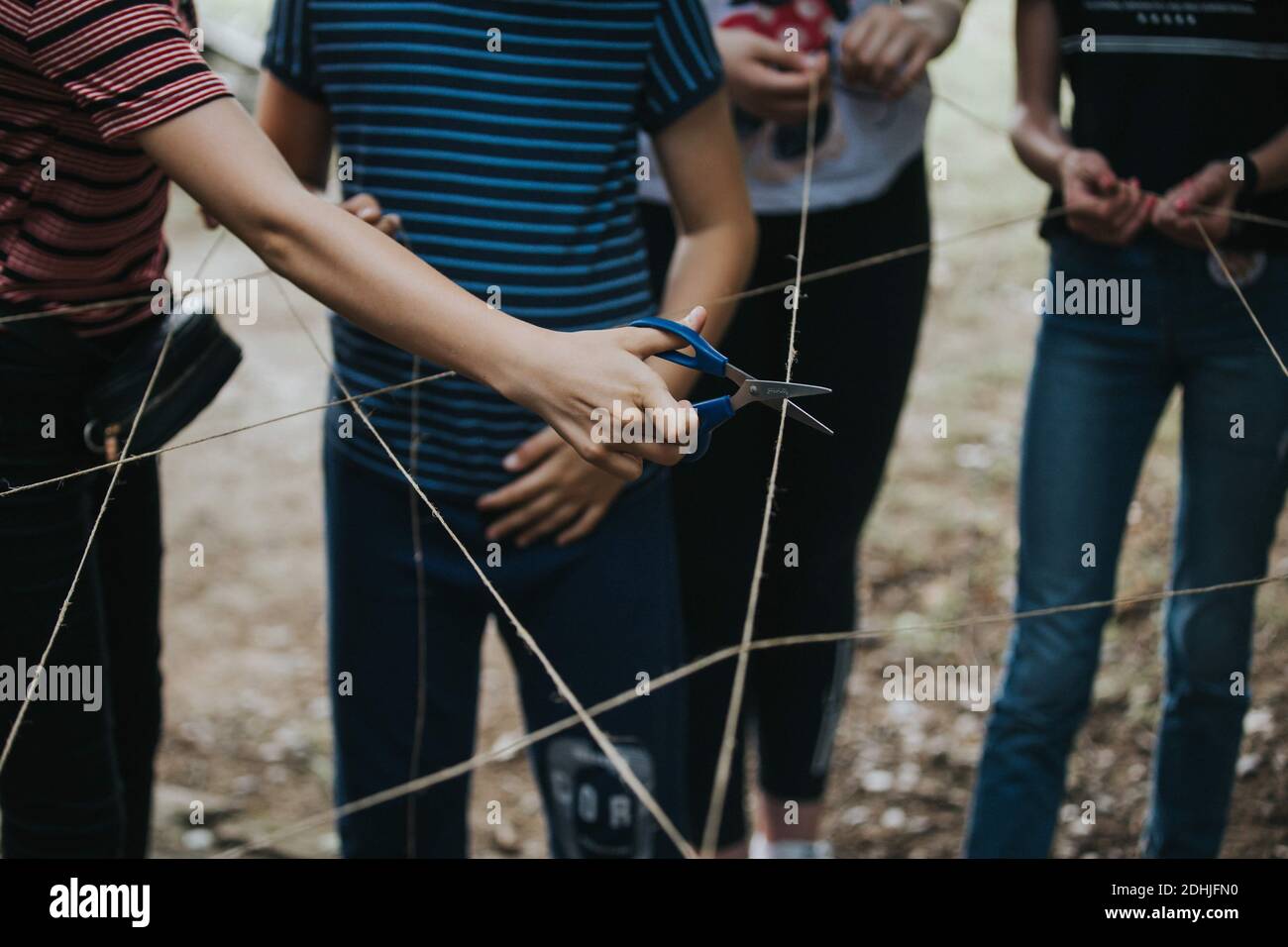 A closeup shot of human hands cutting a rope with shar scissors Stock ...