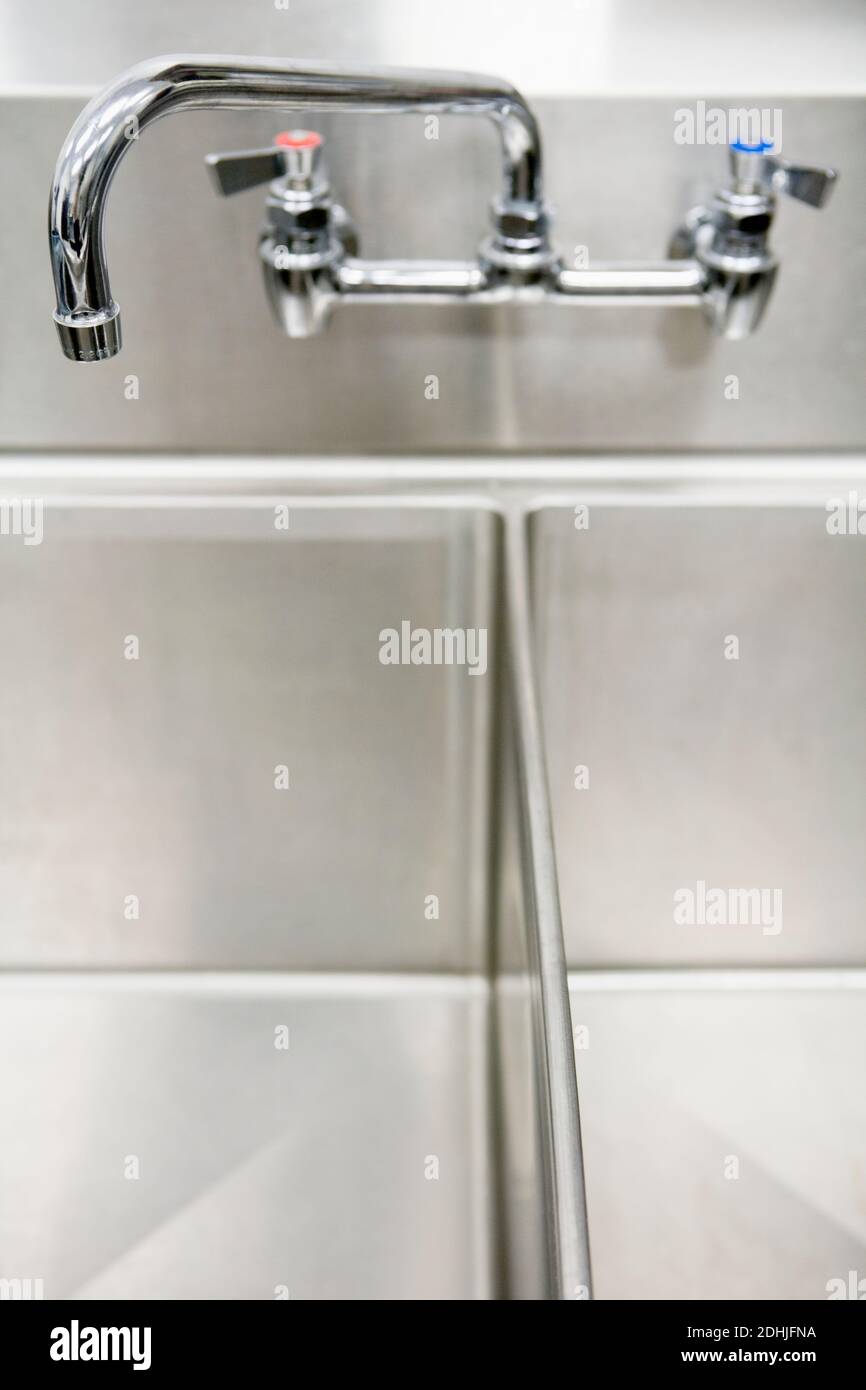 Tap over metal double sink Stock Photo - Alamy
