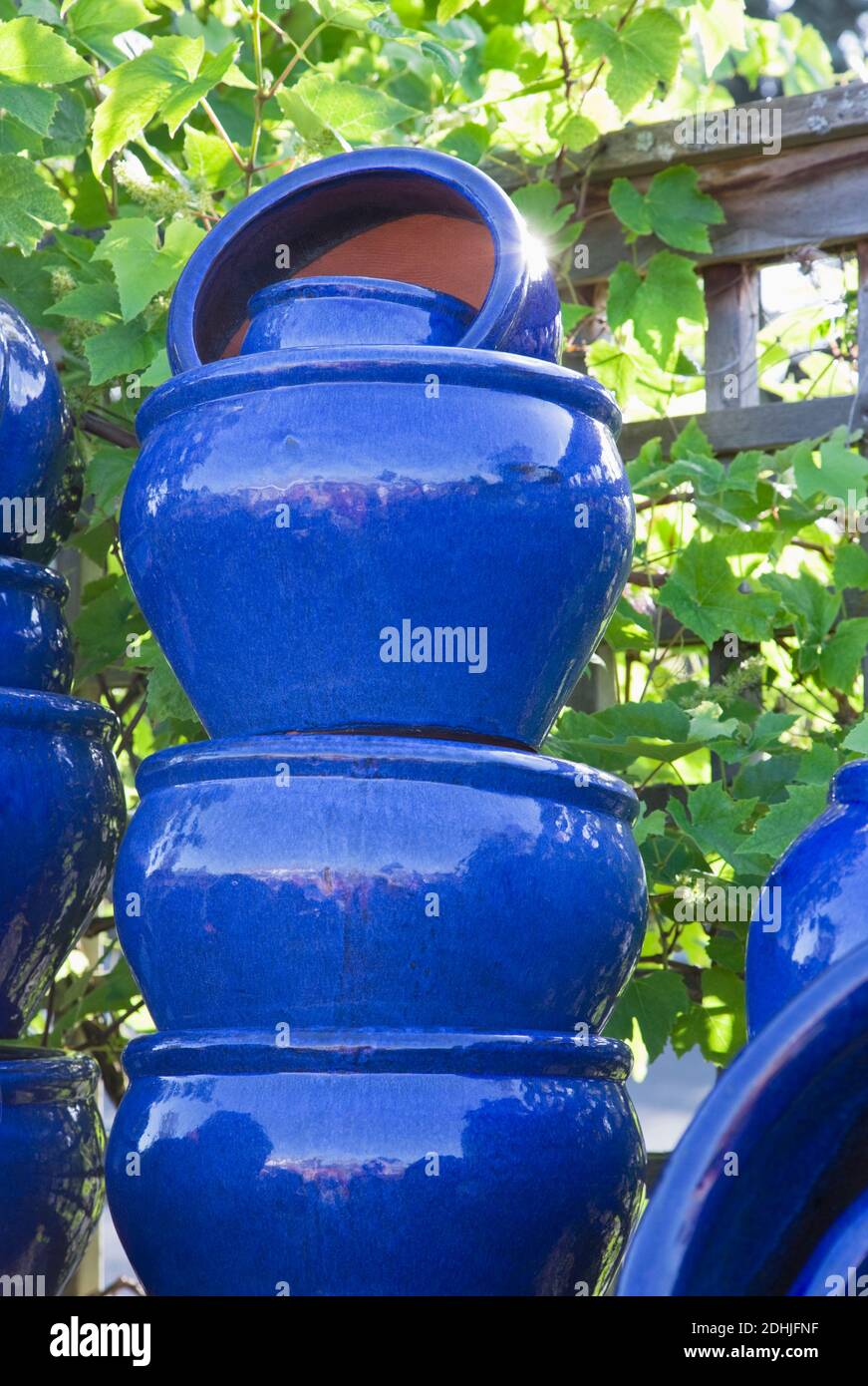Stacked painted blue pots in garden centre Stock Photo - Alamy