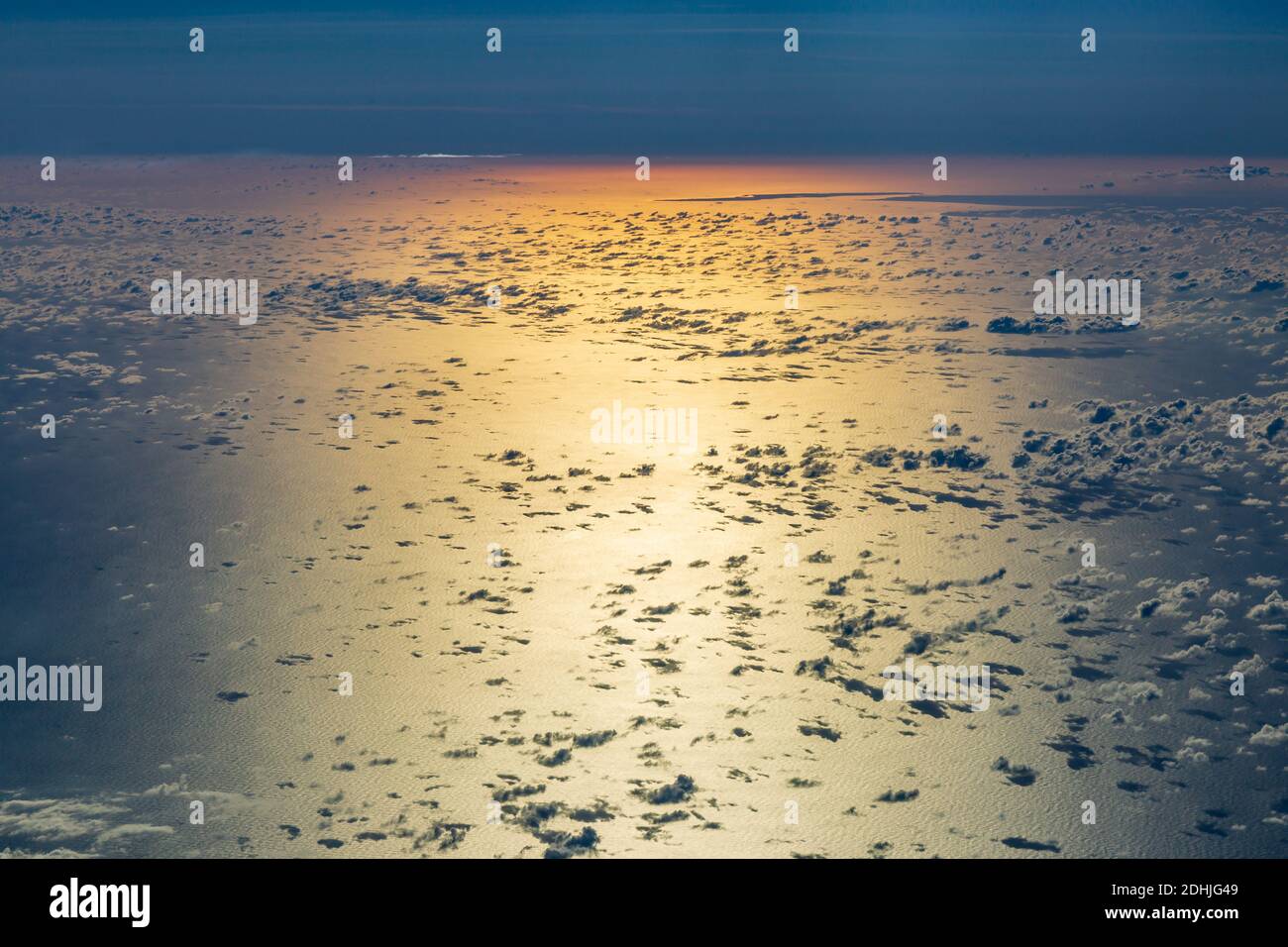Sunset over the ocean, viewed from the flight deck of an airplane Stock ...